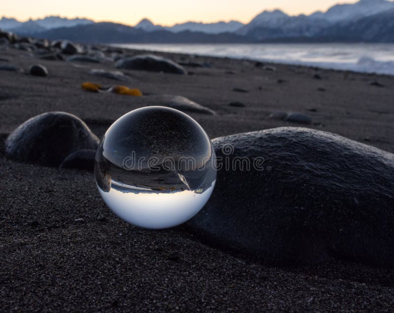 Crystal Ball on Dark Sandy Beach with Rocks Stock Photo - Image of spit ...
