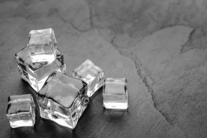 Crystal Clear Ice Cubes on Grey Table. Space for Text Stock Photo ...