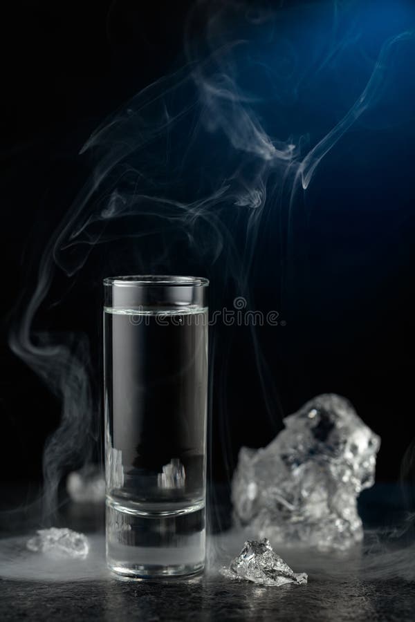 Crystal Clear Vodka or Gin in a Glass on a Black Stone Table Stock ...