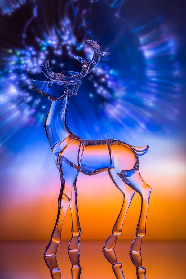 Crystal Reindeer Statuette in Front of Colorful Aurora Stock Photo ...