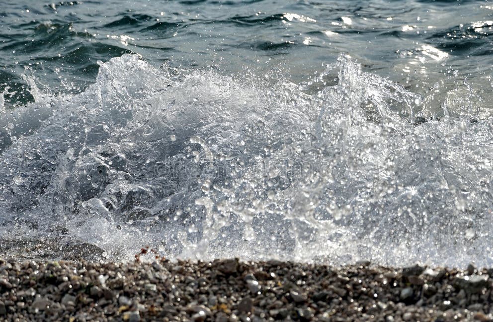 A Crystal Wave of Sea Water Lapping the Sea Shore Stock Image - Image ...