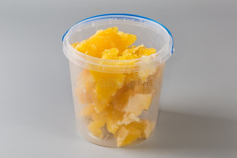 Crystallized Honey in Open Plastic Container on a Gray Background Stock ...