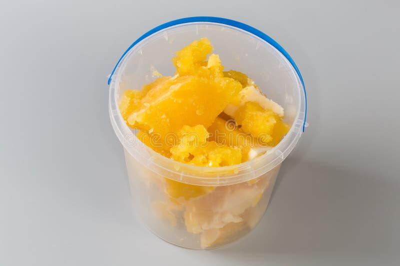 Crystallized Honey in Open Plastic Container on a Gray Background Stock ...