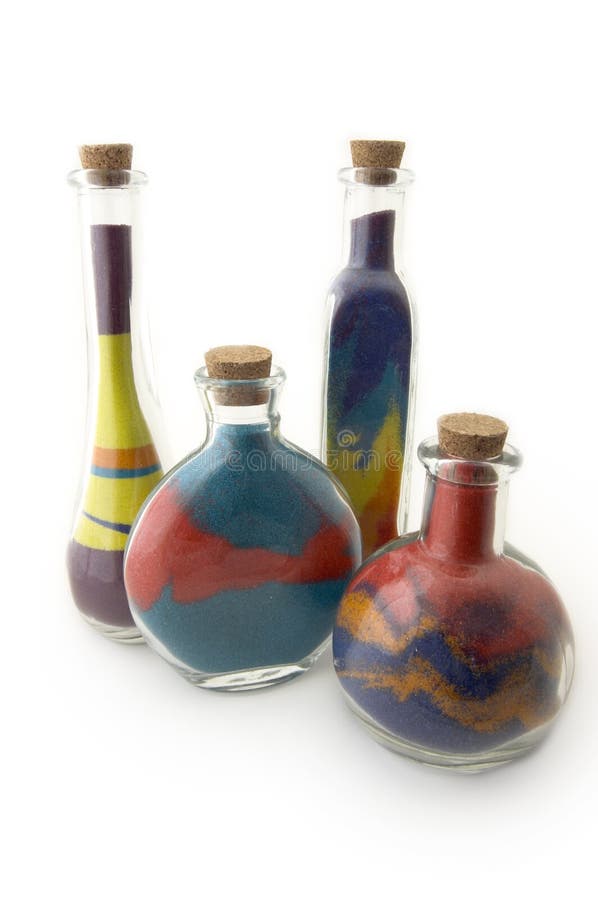 Cuatro Botellas Con La Arena Colorida Imagen de archivo - Imagen de ...