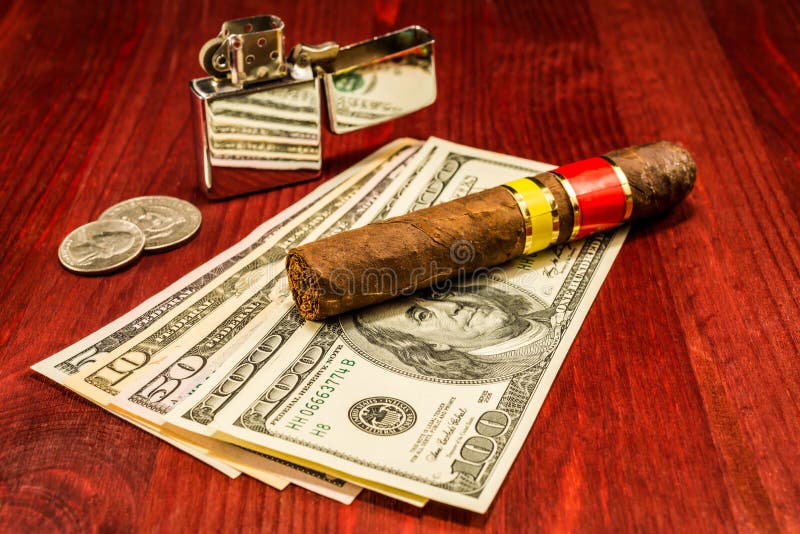 Cuban Cigar on a Several Dollar Bills and Also Coins and Lighter on the ...