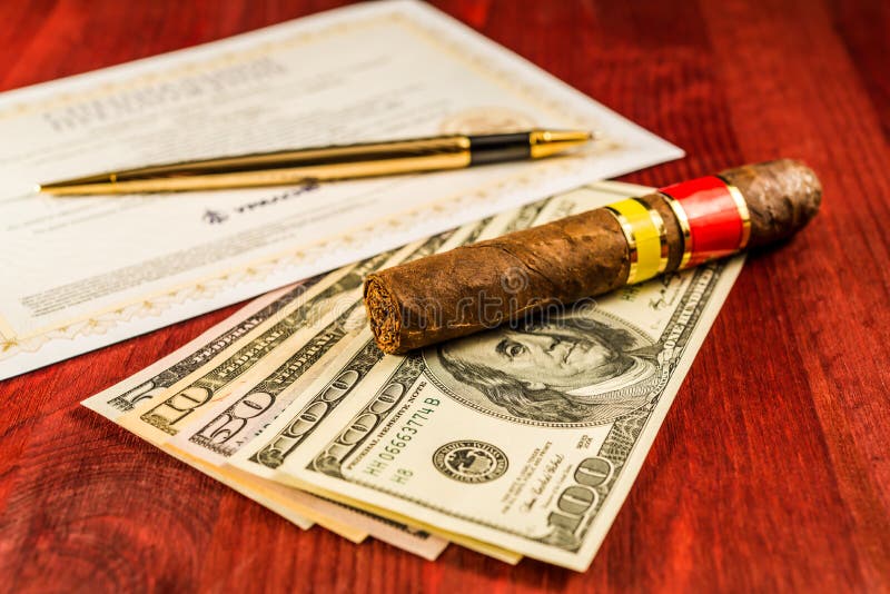 Cuban Cigar on a Several Dollar Bills and Golden Pen with Bank Check on ...
