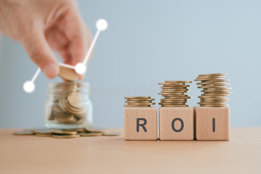 Cube Block Wood Letters ROI and Blurred Money Coin Stack with White ...