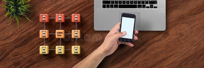 Cubes with Message COMING SOON and Hand with Smartphone and Computer ...