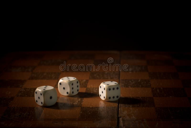 Cubes on an old chessboard stock photo. Image of throw - 104443238