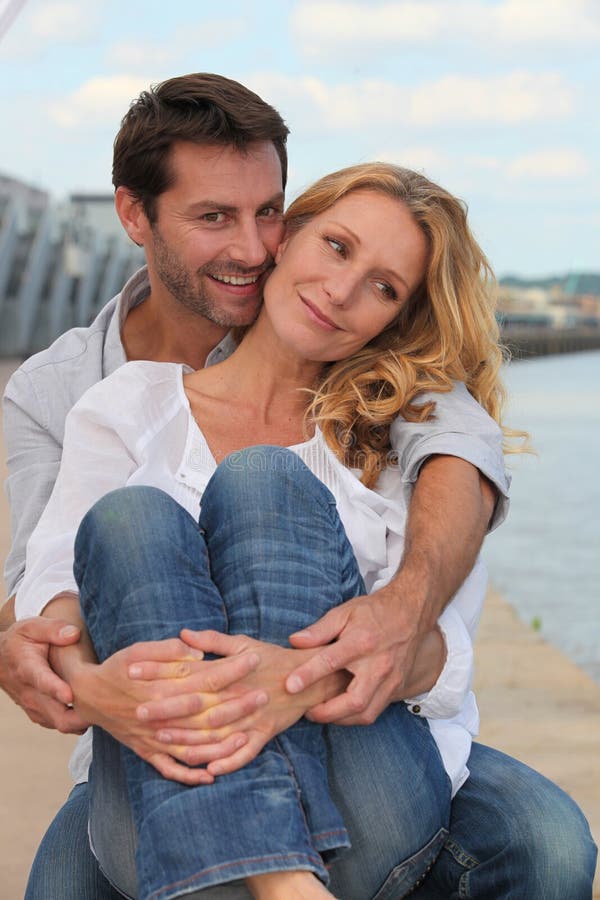 Cuddling on the beach stock photo. Image of 3034, outside - 27918690