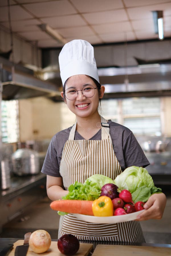Culinary Student Standing Confidently in Training Kitchen with Fresh ...