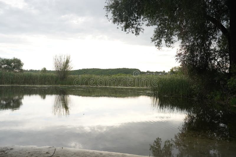 Cumulo Nimbus Clouds at Sunset Reflected in a Lake Stock Photo - Image ...