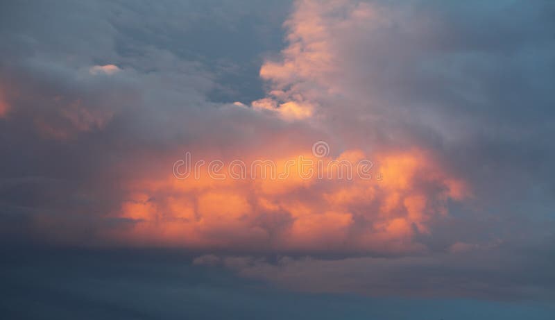 Cumulus clouds at sunset stock image. Image of orange - 72533117