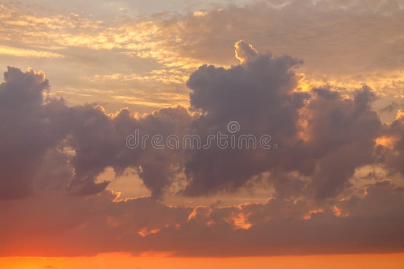 Cumulus clouds at sunset stock image. Image of orange - 268538703