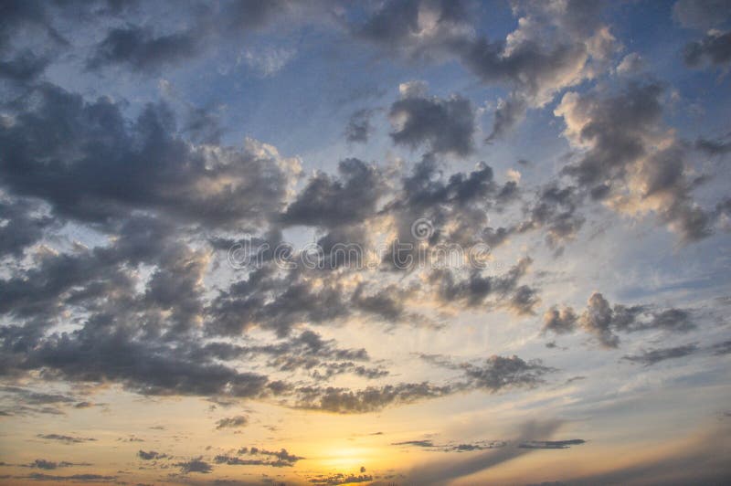 Cumulus Sunset Clouds with Sun Setting Down Stock Image - Image of ...