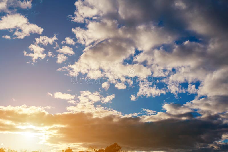 Cumulus Sunset Clouds with Sun Setting Down Stock Photo - Image of ...