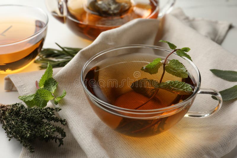 Cup of Aromatic Herbal Tea with Rosemary, Sage, Thyme and Mint on Table ...