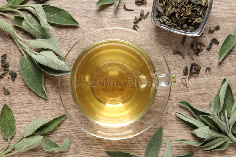 Cup of Aromatic Sage Tea, Dry and Fresh Leaves on Wooden Table, Flat ...