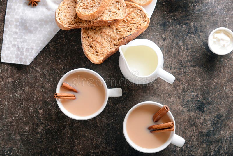 Cup of Aromatic Tea with Cinnamon, Milk and Fresh Bread on Table Stock ...