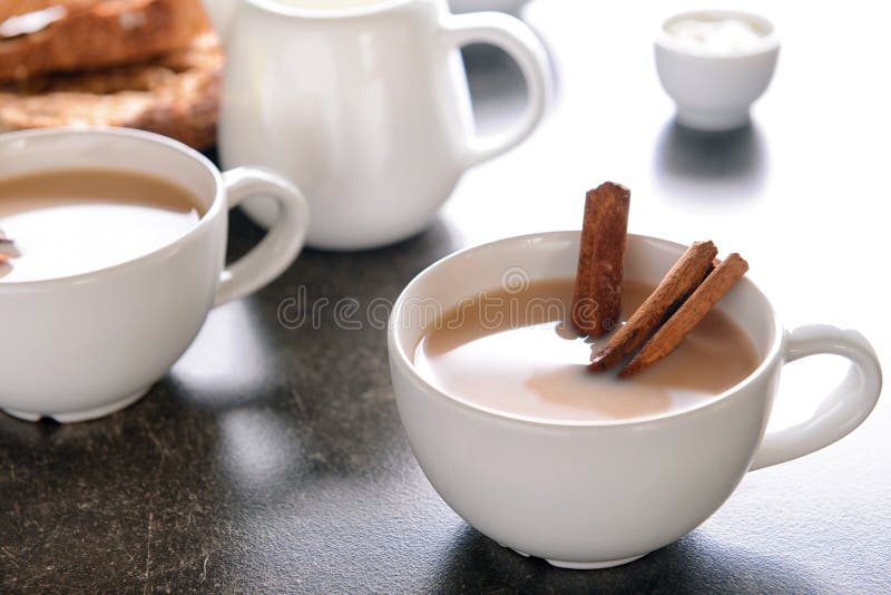 Cup of Aromatic Tea with Cinnamon and Milk on Table Stock Image - Image ...