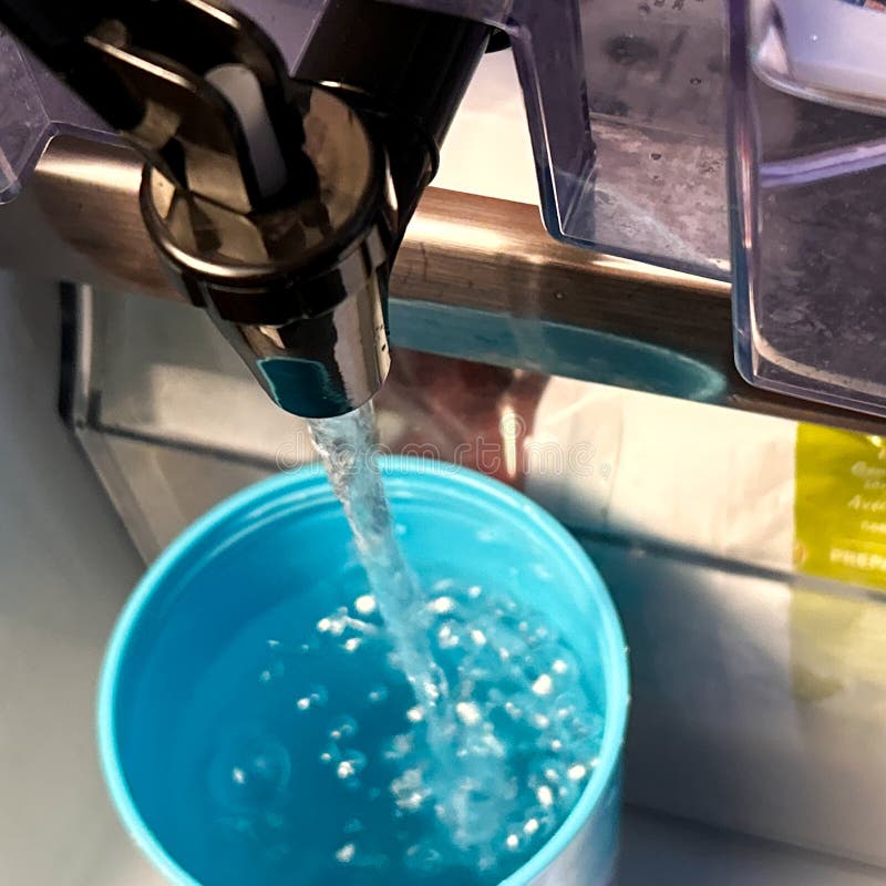 A Cup Being Filled by a Water Filter Dispenser Stock Photo - Image of ...