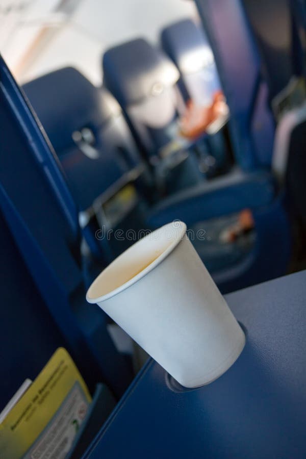 A Cup with a Beverage on a Table in a Flying Plane. Stock Photo - Image ...
