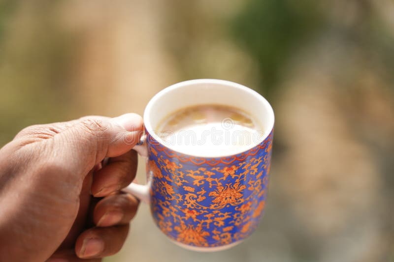 A Cup of Bhutani Tea is Held in Hand Stock Photo - Image of held ...