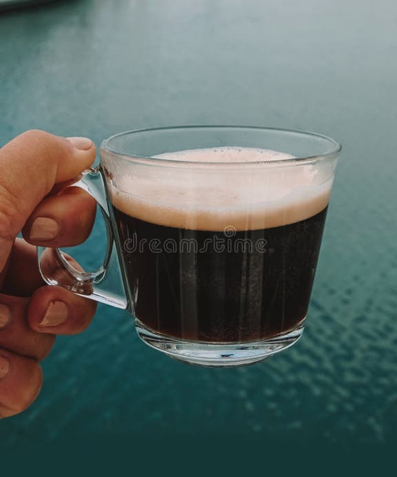 A Cup of Black Coffee in Hand. Stock Photo - Image of beverage, grains ...