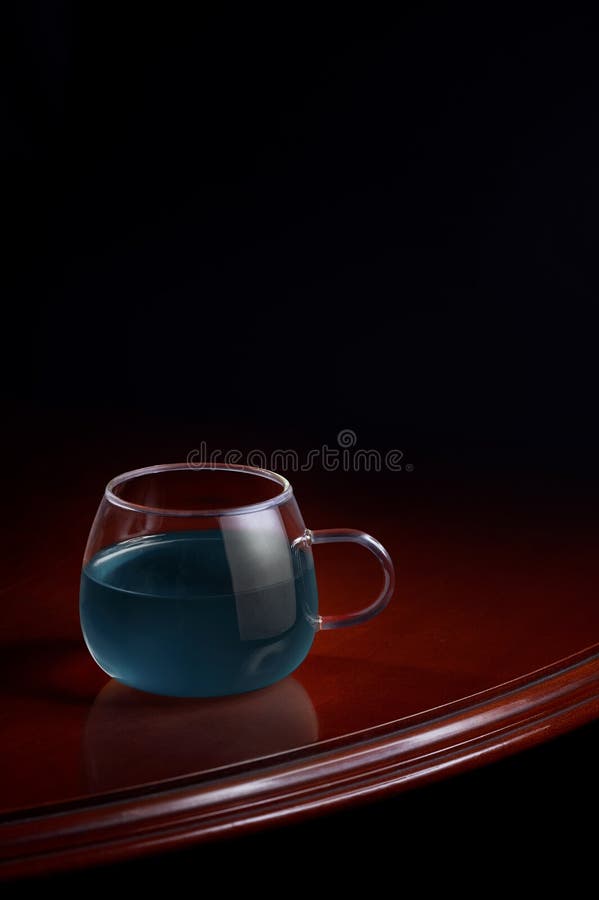 Cup of a Blue Infusion on a Luxurious Table with a Black Background ...