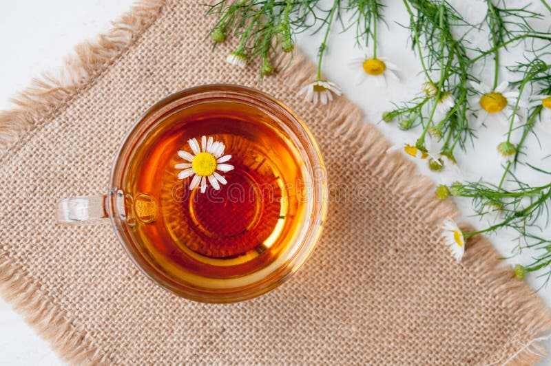 A Cup of Chamomile Tea and Chamomile Flowers on the Table, Top View ...