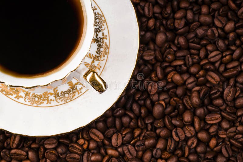 A Cup of Coffee on the Background of Coffee Beans Stock Photo - Image ...
