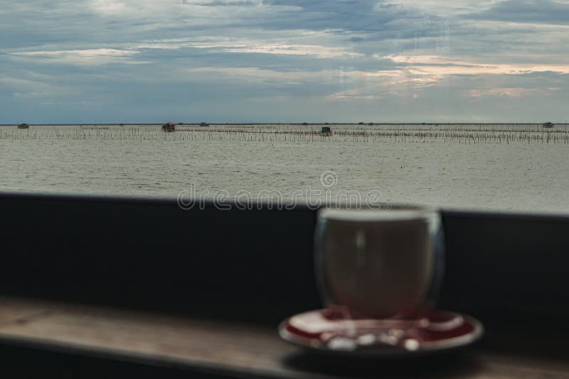 Cup of Coffee on the Bar with Evening Sea View. Stock Image - Image of ...
