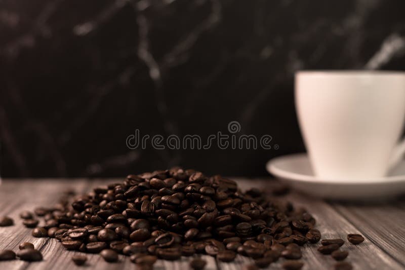 A Cup of Coffee and Coffee Beans on a Dark Background. Roasted Coffee ...