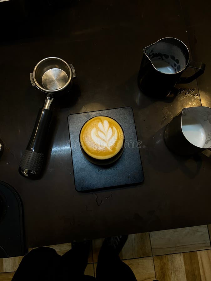 Cup of Coffee with Beautiful Latte Art on Black Table with Coffee Maker ...