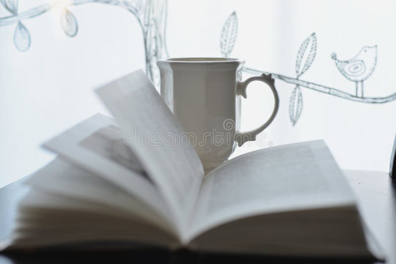 Cup of Coffee and a Book by the Window with Patterned Curtains Stock ...