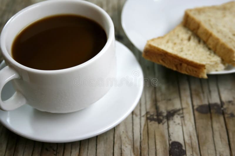 A cup of coffee and bread stock photo. Image of baked - 36399424