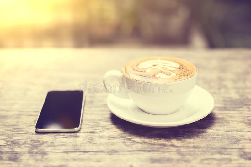 Cup of Coffee and Cell Phone on a Table Outdoors Stock Image - Image of ...