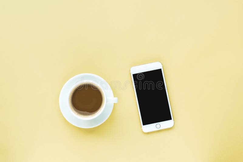 Cup of Coffee and Cell Phone on a Yellow Background. Top View, Flat Lay ...