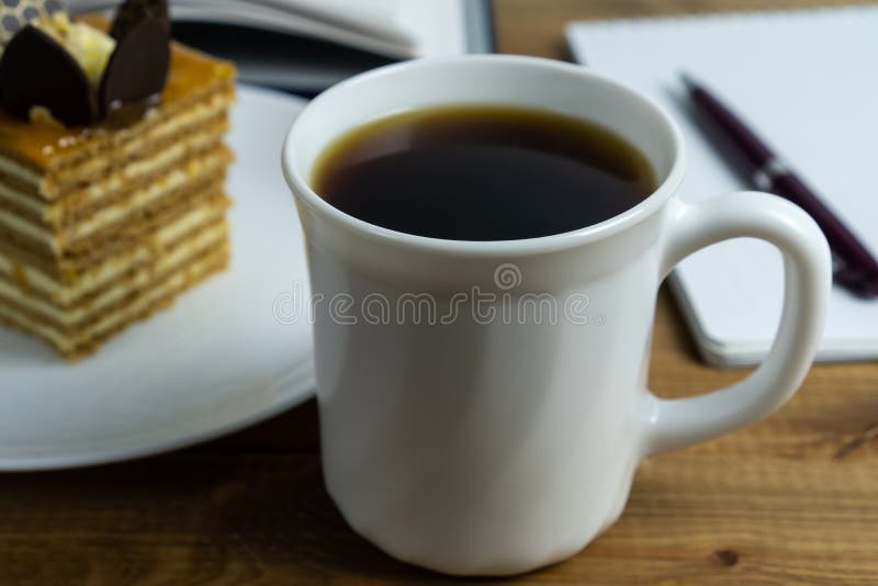Cup of Coffee Close Up and Cake on the Plate on Wooden Table. Concept ...