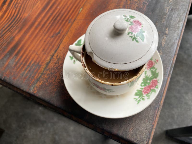 A Cup of Coffee with Half Covered on a Wooden Table Stock Image - Image ...