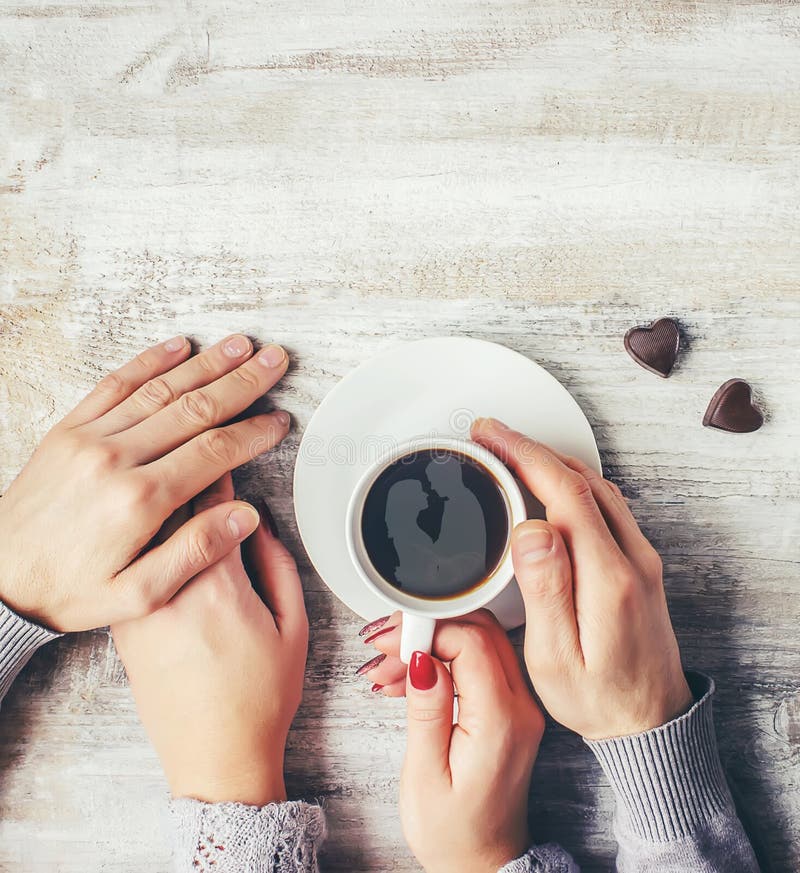 A Cup of Coffee in the Hands of Lovers. Silhouette in a Cup Stock Photo ...