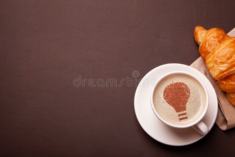 Cup of Coffee with the Idea of a Light Bulb on the Foam. Coffee Gives ...