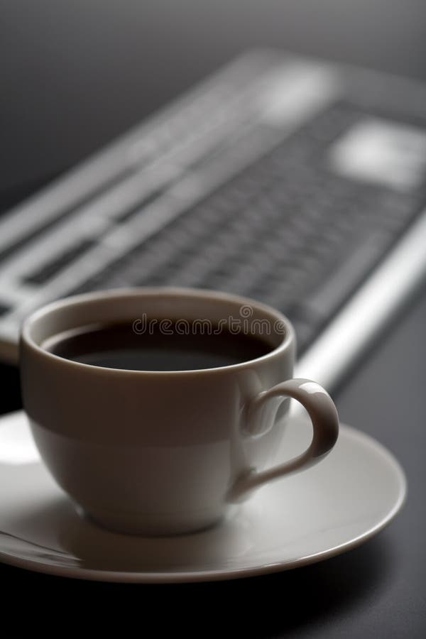 Cup of coffee and keyboard stock photo. Image of keyboard - 6772158