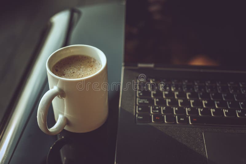 Cup of coffee and laptop. stock image. Image of breakfast - 106770171