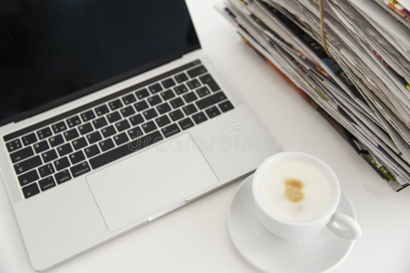 Cup of Coffee, Laptop and Pile of Newspapers Stock Photo - Image of ...