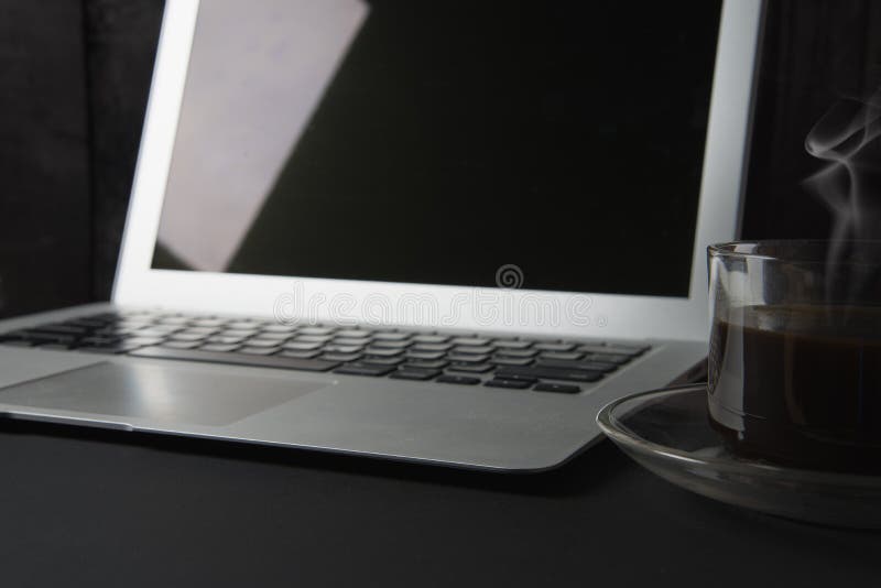 Cup of coffee and laptop stock image. Image of restaurant - 84467763
