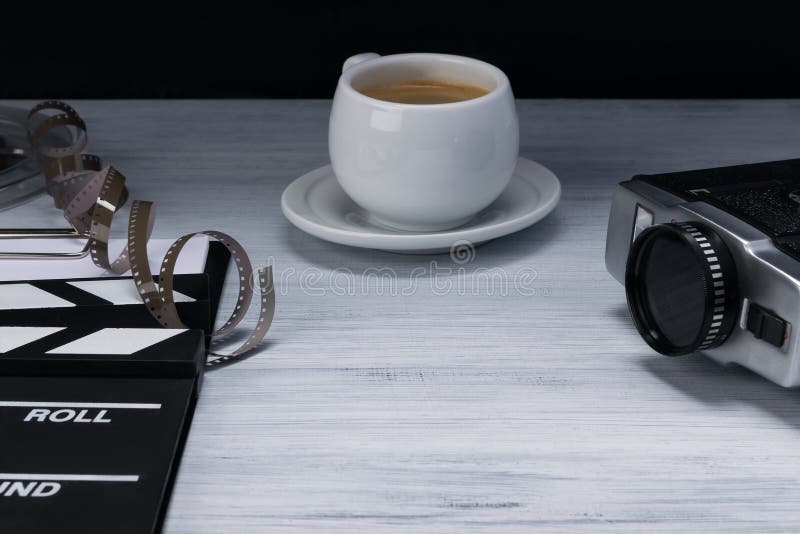 Cup of Coffee on a Light Gray Table Next To Filming Objects Stock Photo ...
