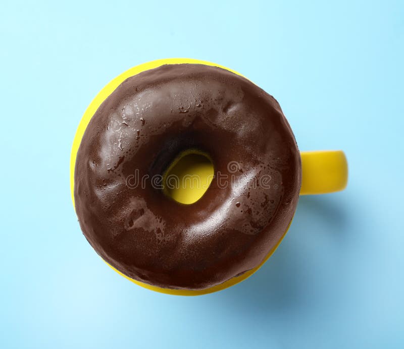 Cup of Coffee Made with Donut on Blue Background, Top View Stock Photo ...