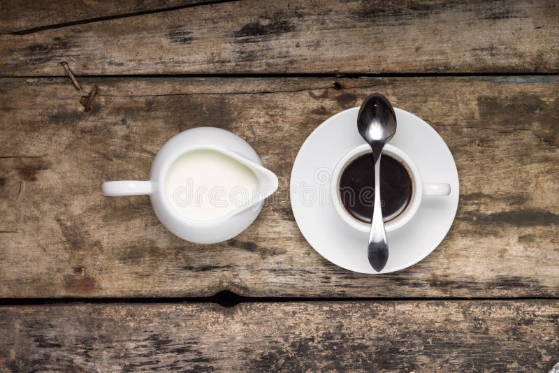 Cup of Coffee with Milk Jug on Wood Background. Top View Stock Photo ...