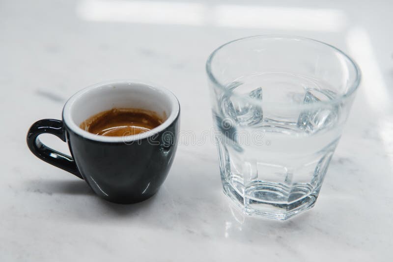 Cup with Coffee Near a Glass of Water Stock Photo - Image of beverage ...